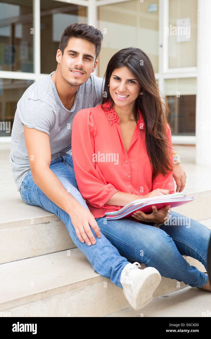 Couple of happy students at the university campus Stock Photo - Alamy