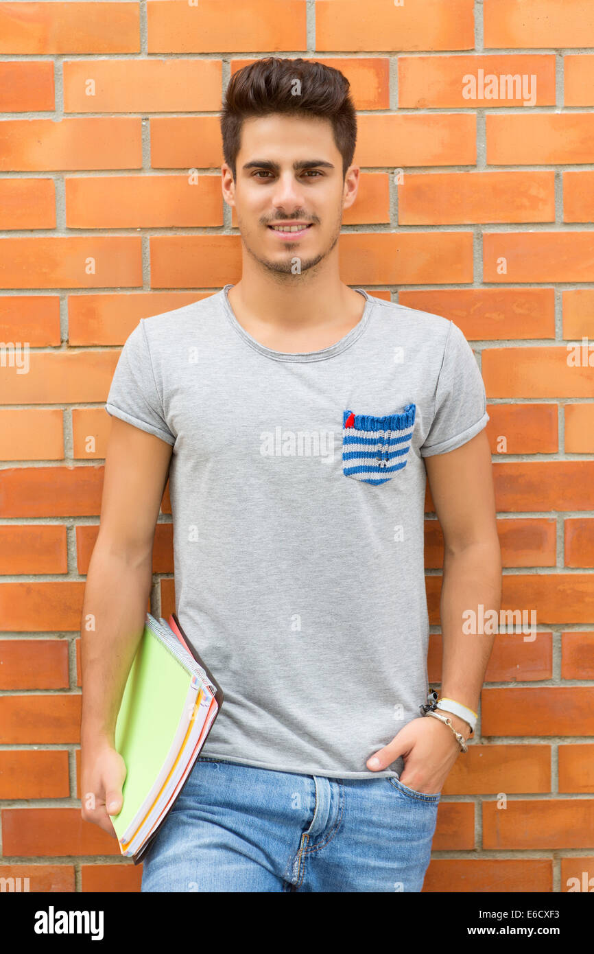 Happy student relaxing at the university campus Stock Photo - Alamy