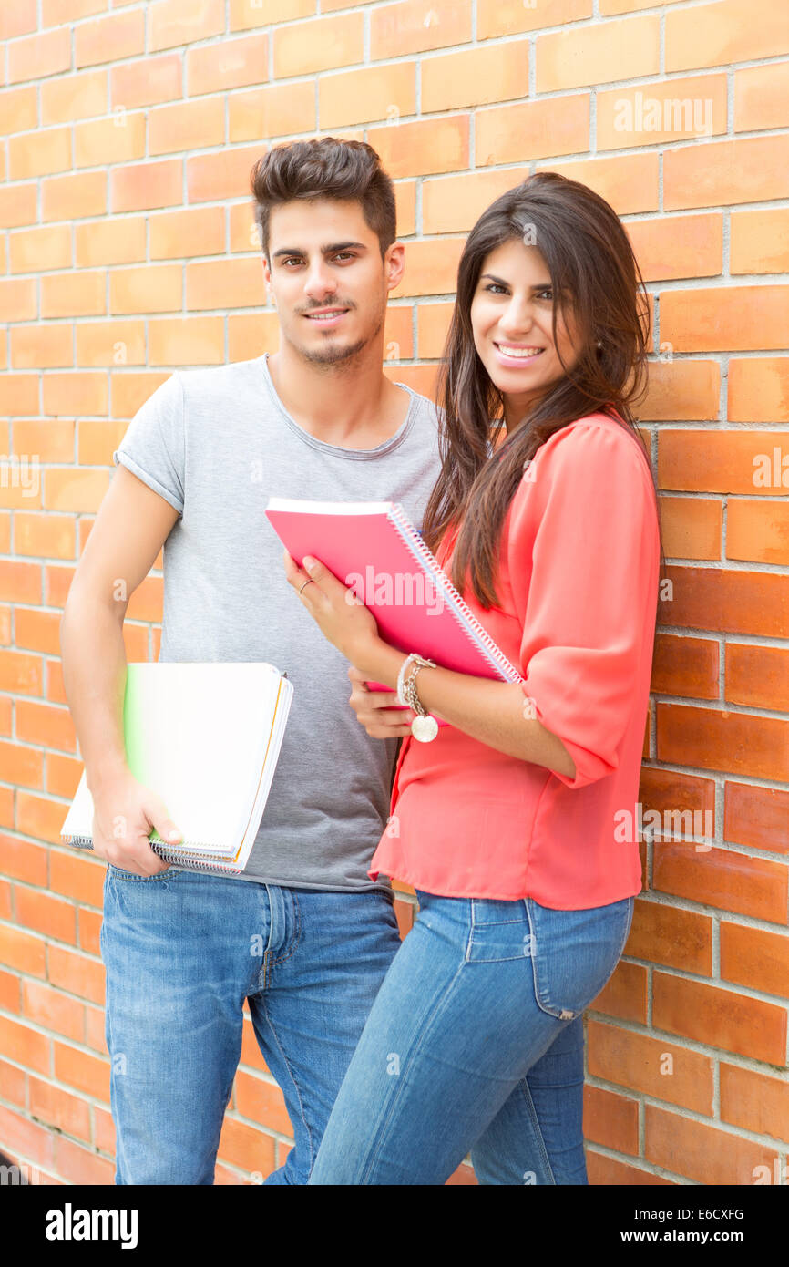 Couple of happy students at the university campus Stock Photo - Alamy