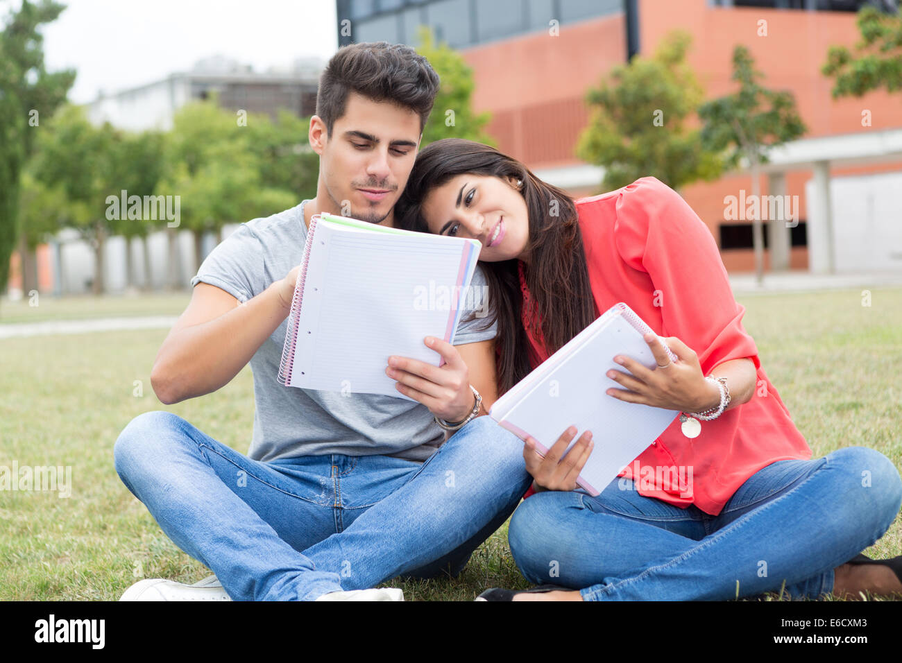 Couple of happy students at the university campus Stock Photo - Alamy