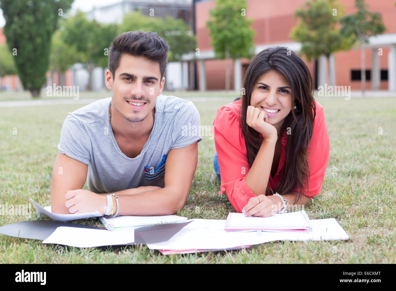 Couple of happy students at the university campus Stock Photo - Alamy