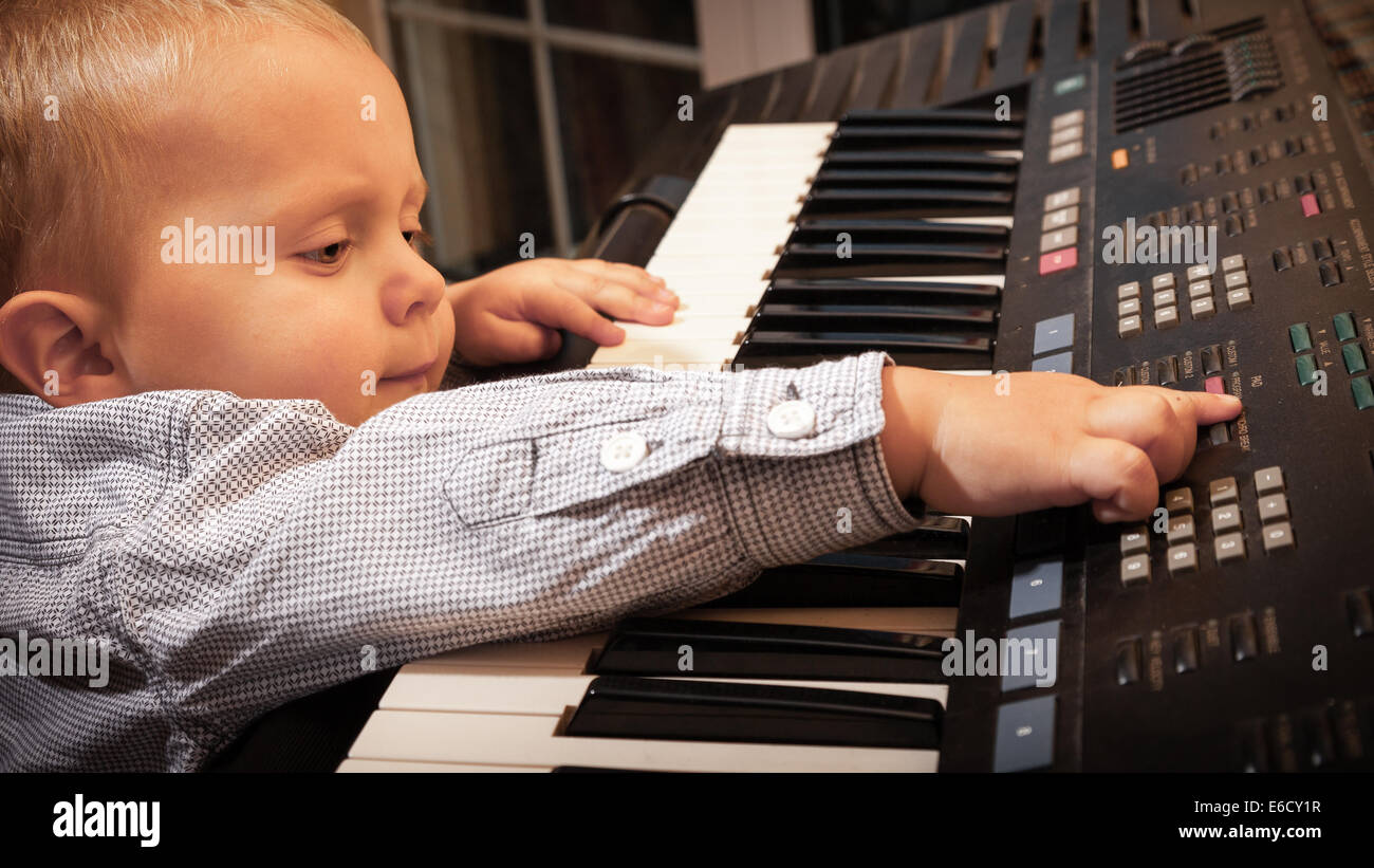 Boy child kid playing on digital keyboard piano synthesizer Stock Photo ...