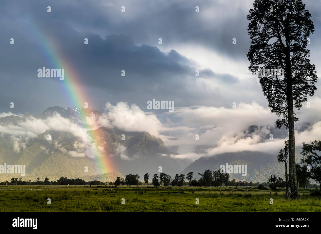 Storm clouds with rainbow, pasture against the Southern Alps, Fox ...