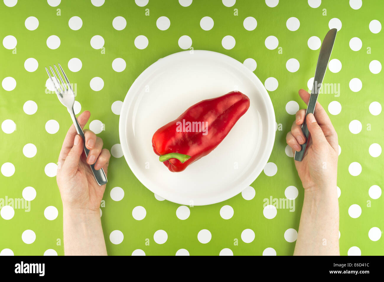 Woman eating fresh raw red pepper on a white plate, top view Stock ...