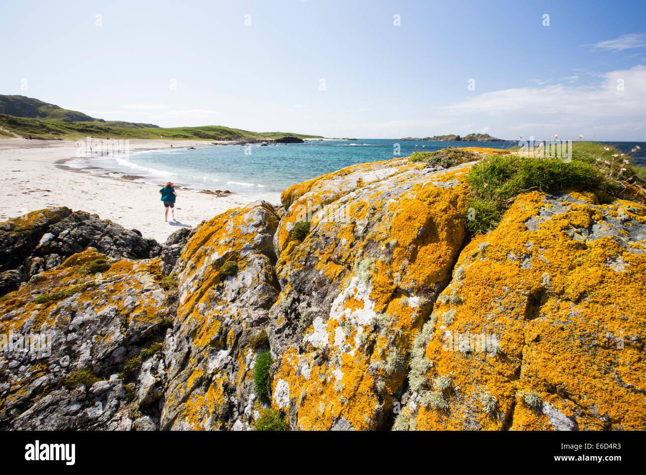 Aquamarine seas and lichen covered rock on the West coast of Iona, off ...