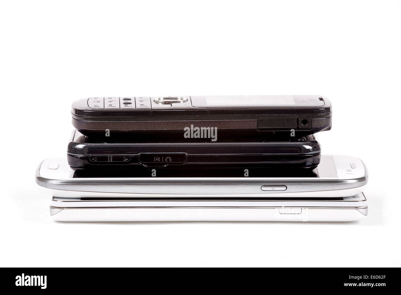 Stack of older model cell phones and smartphones isolated on white ...