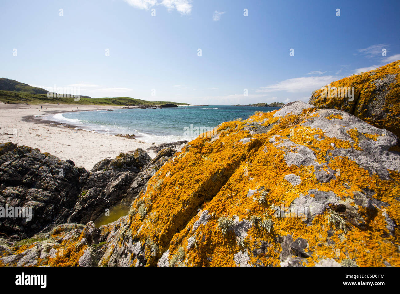 Aquamarine seas and lichen covered rock on the West coast of Iona, off ...