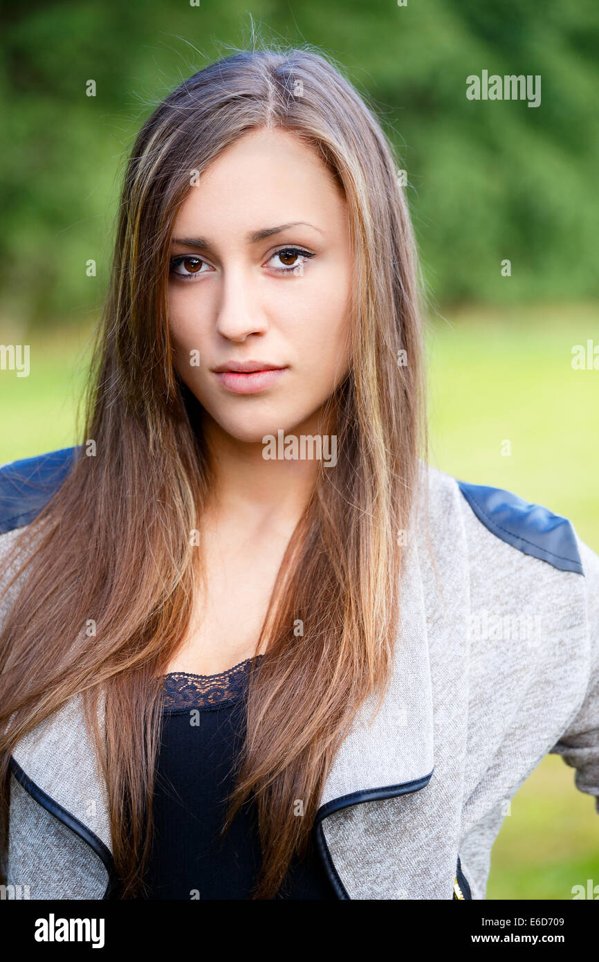 Portrait of a charming lady woman girl outdoor with green background ...