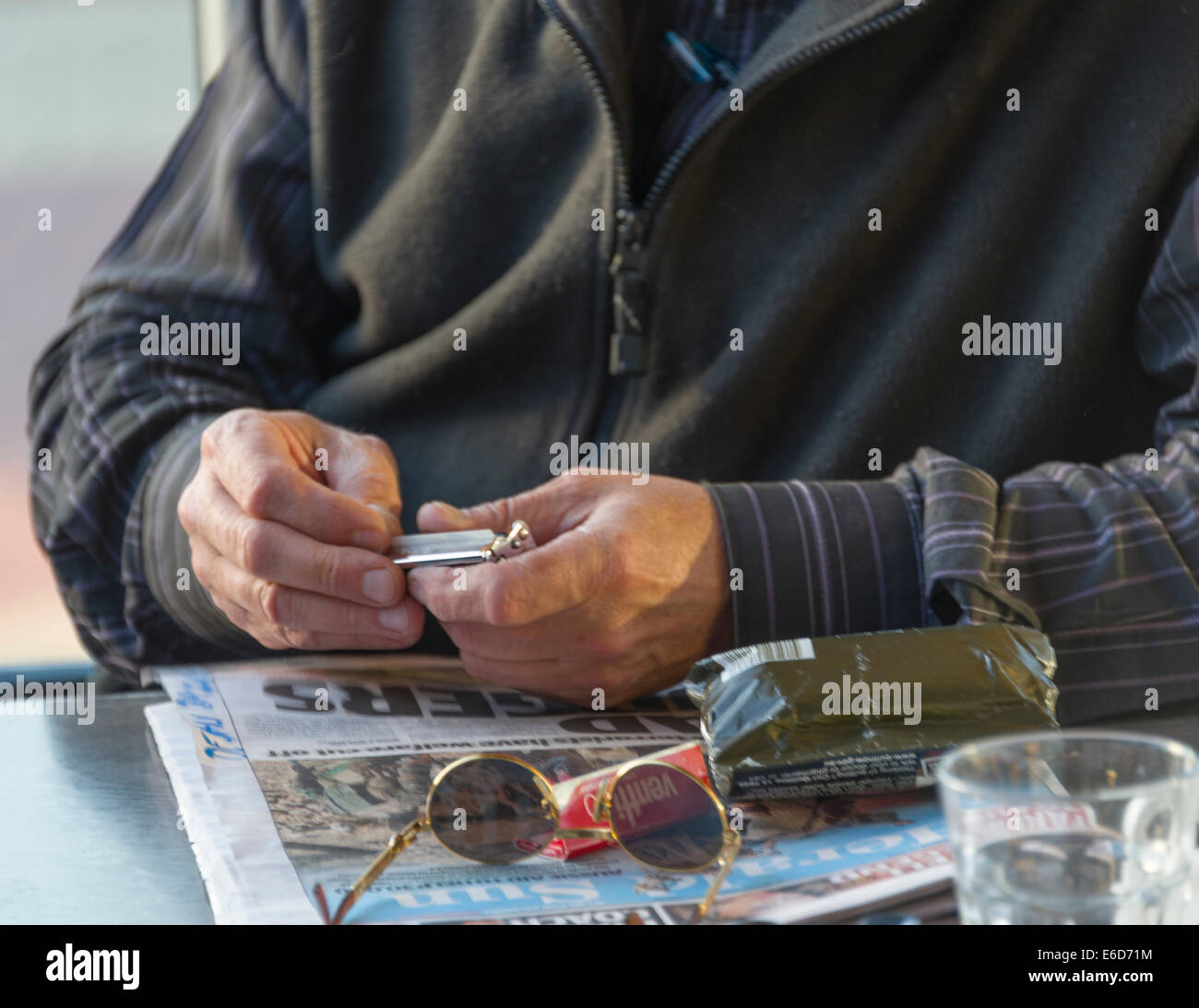 middle aged man smoking cigarettes in cafe Stock Photo - Alamy