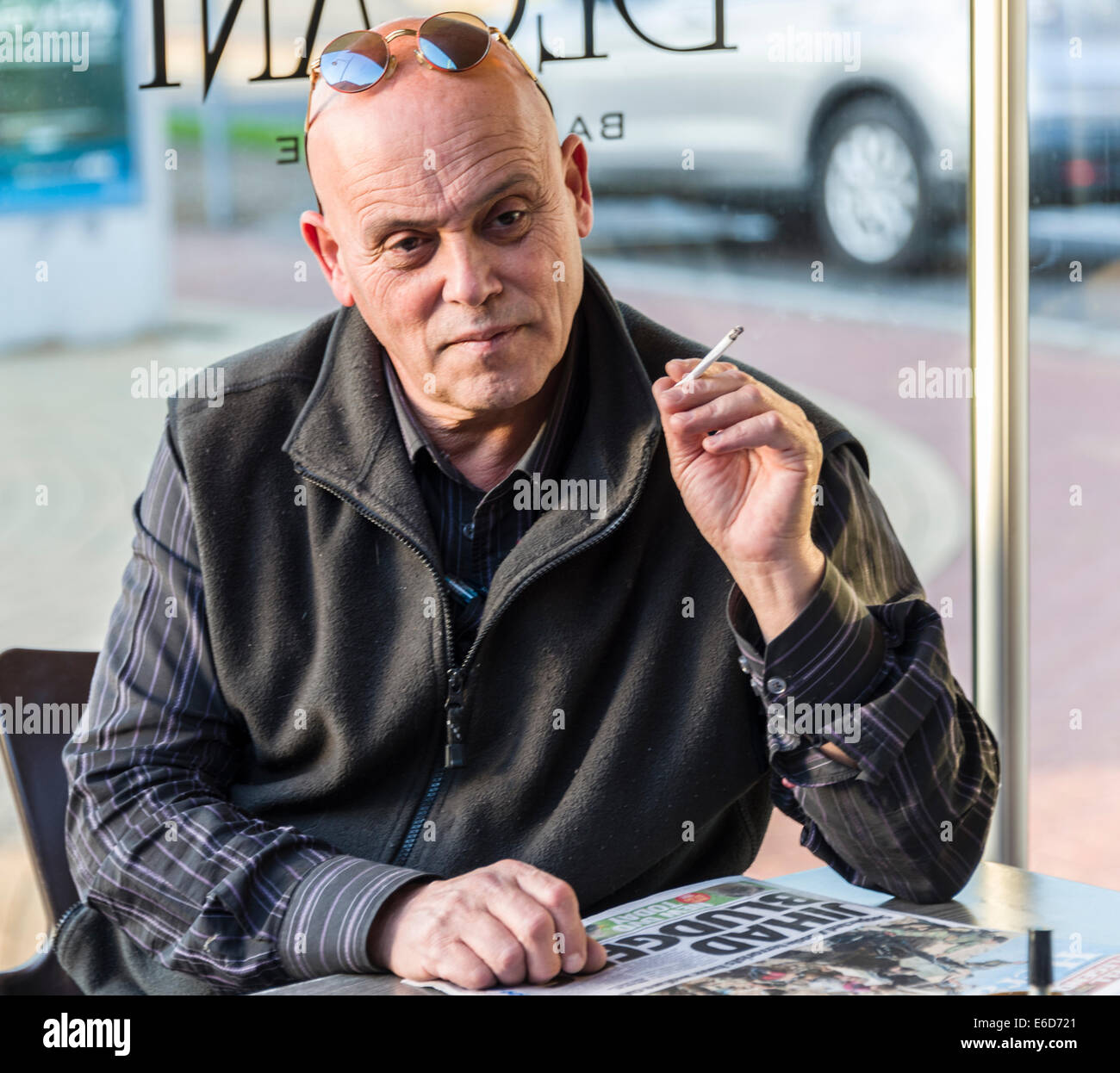 middle aged man smoking cigarettes in cafe Stock Photo - Alamy