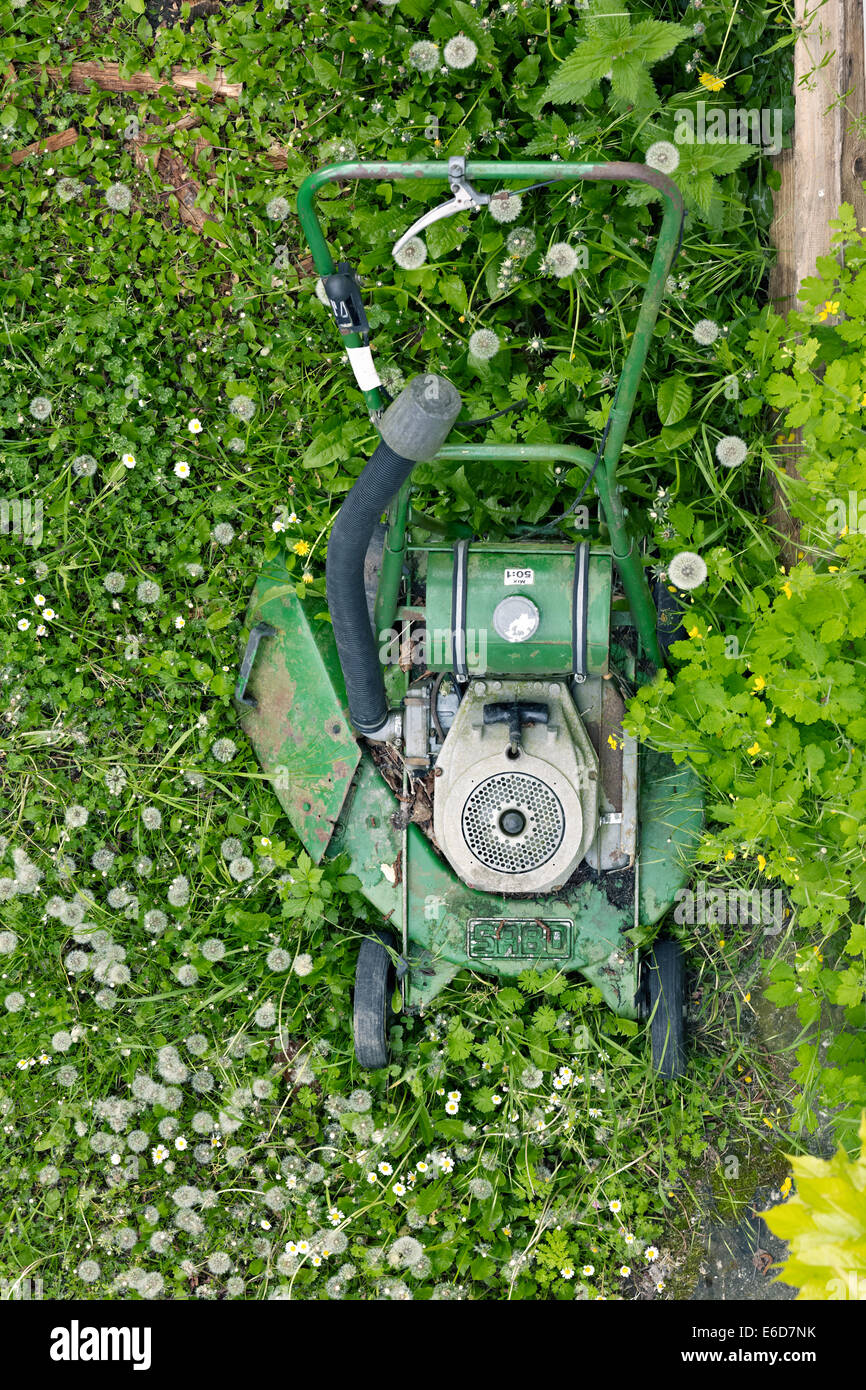 Old green lawn mower standing on savaged meadow, elevated view Stock ...