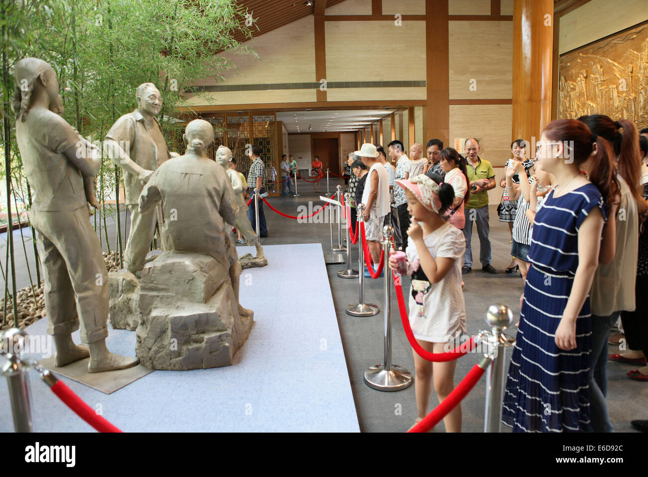Guang'an. 21st Aug, 2014. Visitors watch a sculpture in the lobby of ...