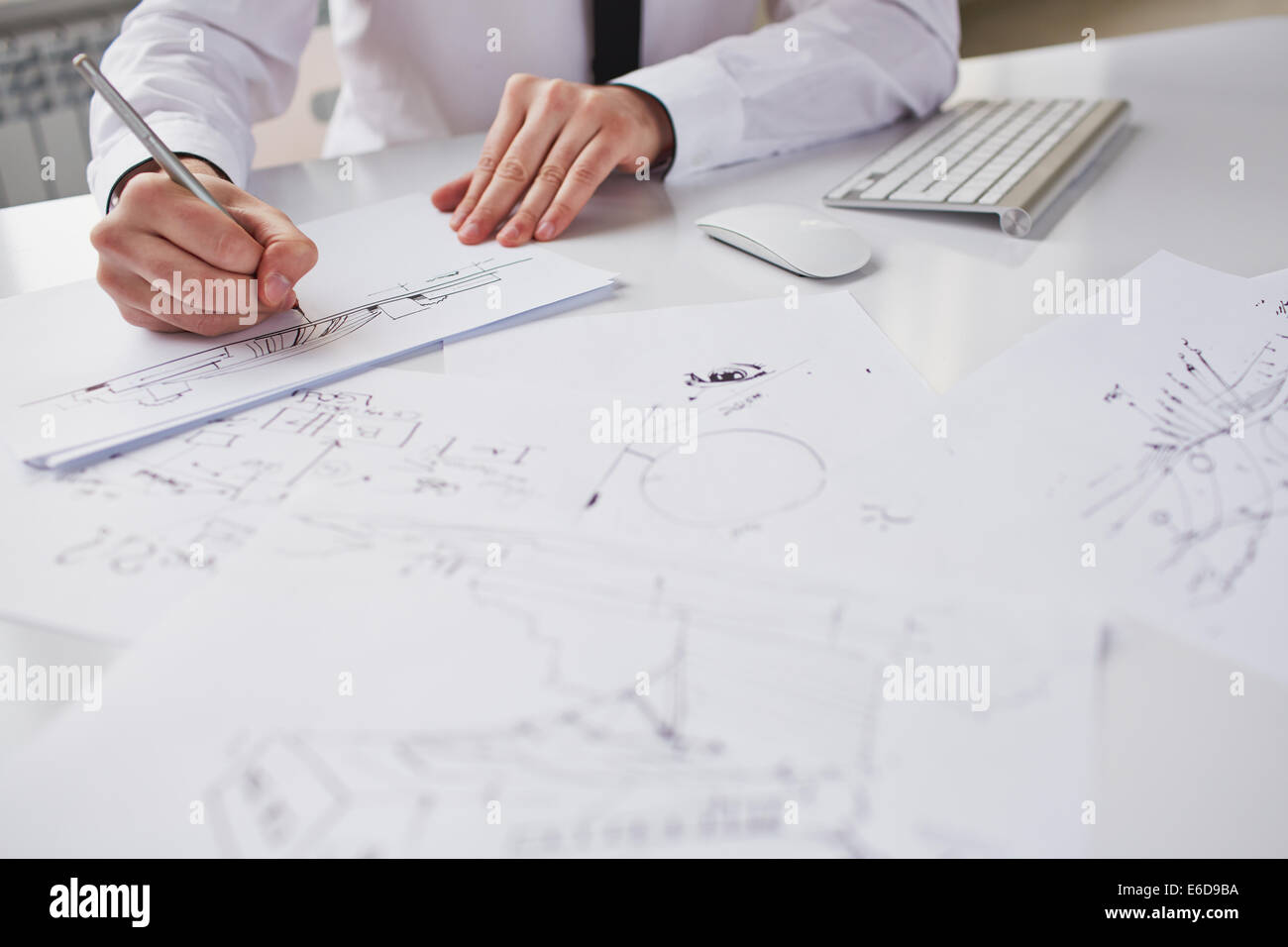 Businessman drawing sketches at workplace Stock Photo - Alamy