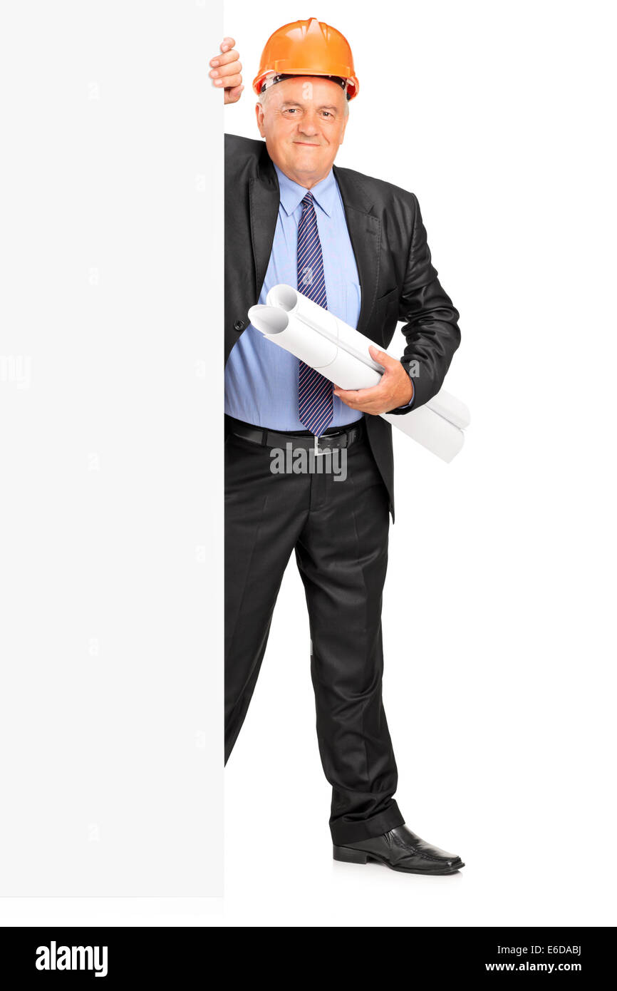 Mature construction worker standing behind panel Stock Photo - Alamy