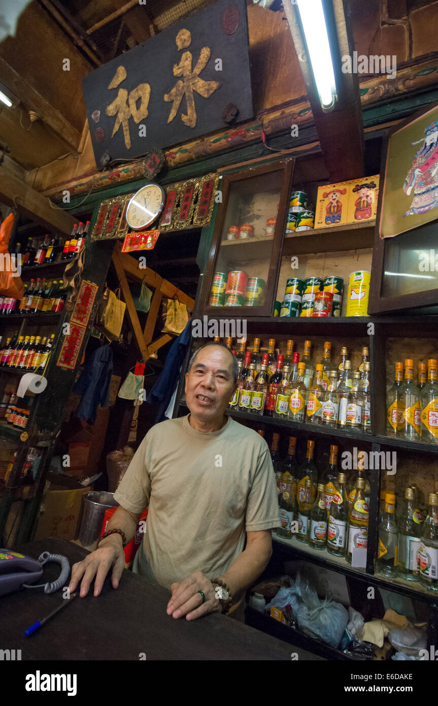 Owner of a traditional Chinese grocers, inside of his shop, Hong Kong ...