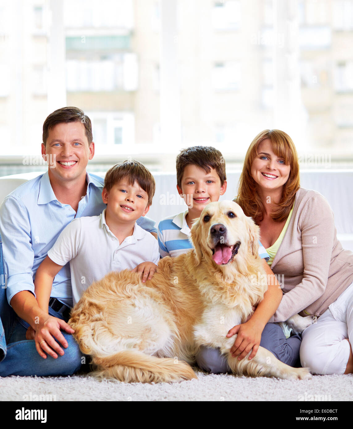 Portrait of happy family with a dog Stock Photo - Alamy