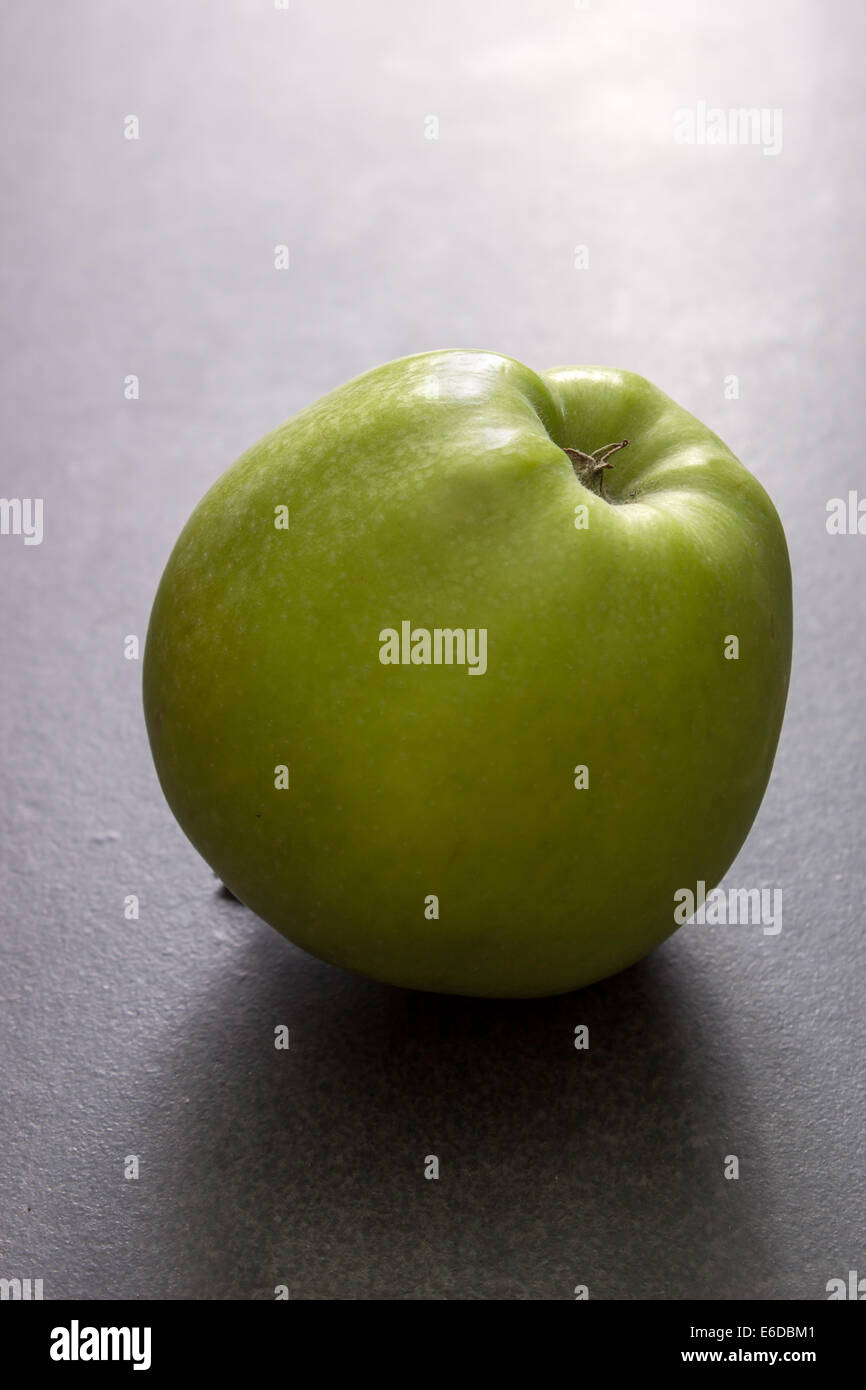 Fresh ripe green apple on table, backlit Stock Photo - Alamy