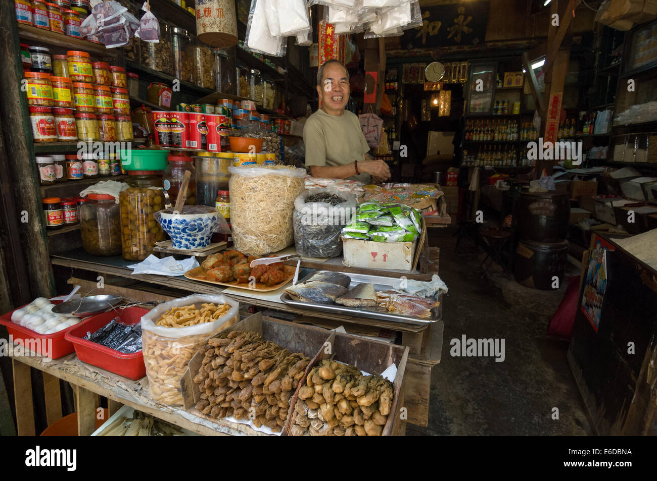 Owner of a traditional Chinese grocers, inside of his shop, Hong Kong ...