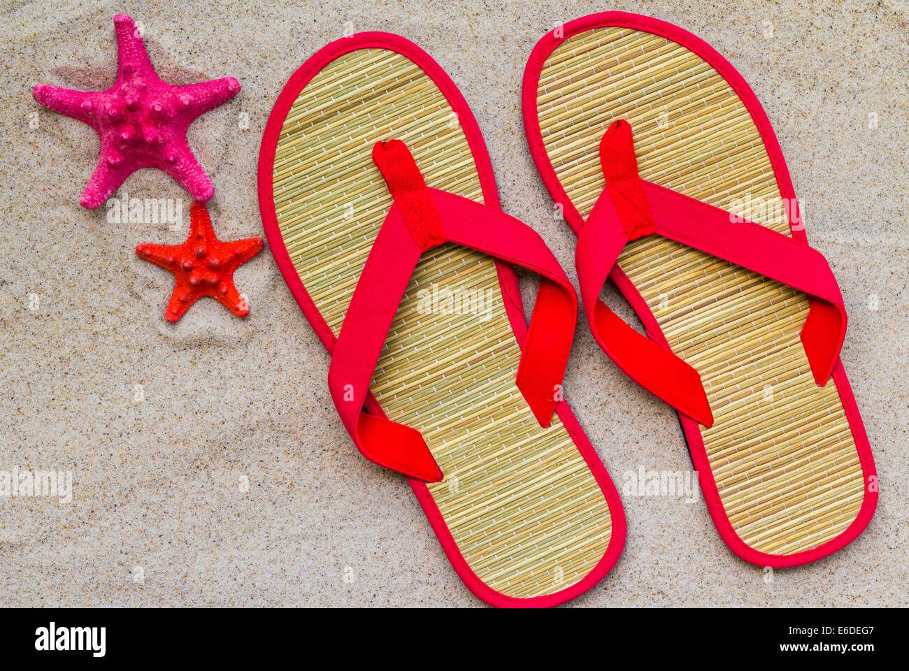 Sea shells and flip flops on beach sand Stock Photo - Alamy