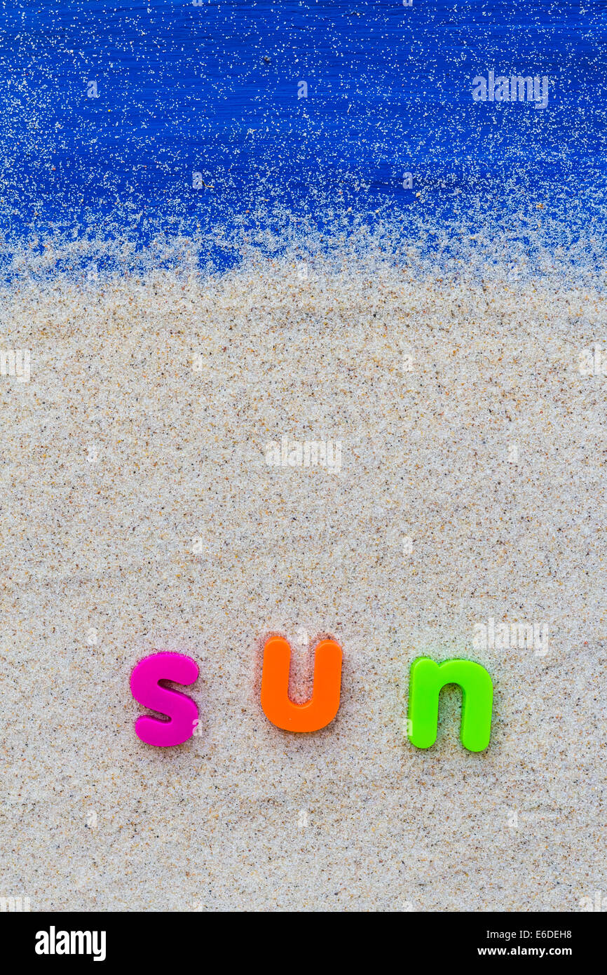 The word sun laid sand and blue board Stock Photo - Alamy