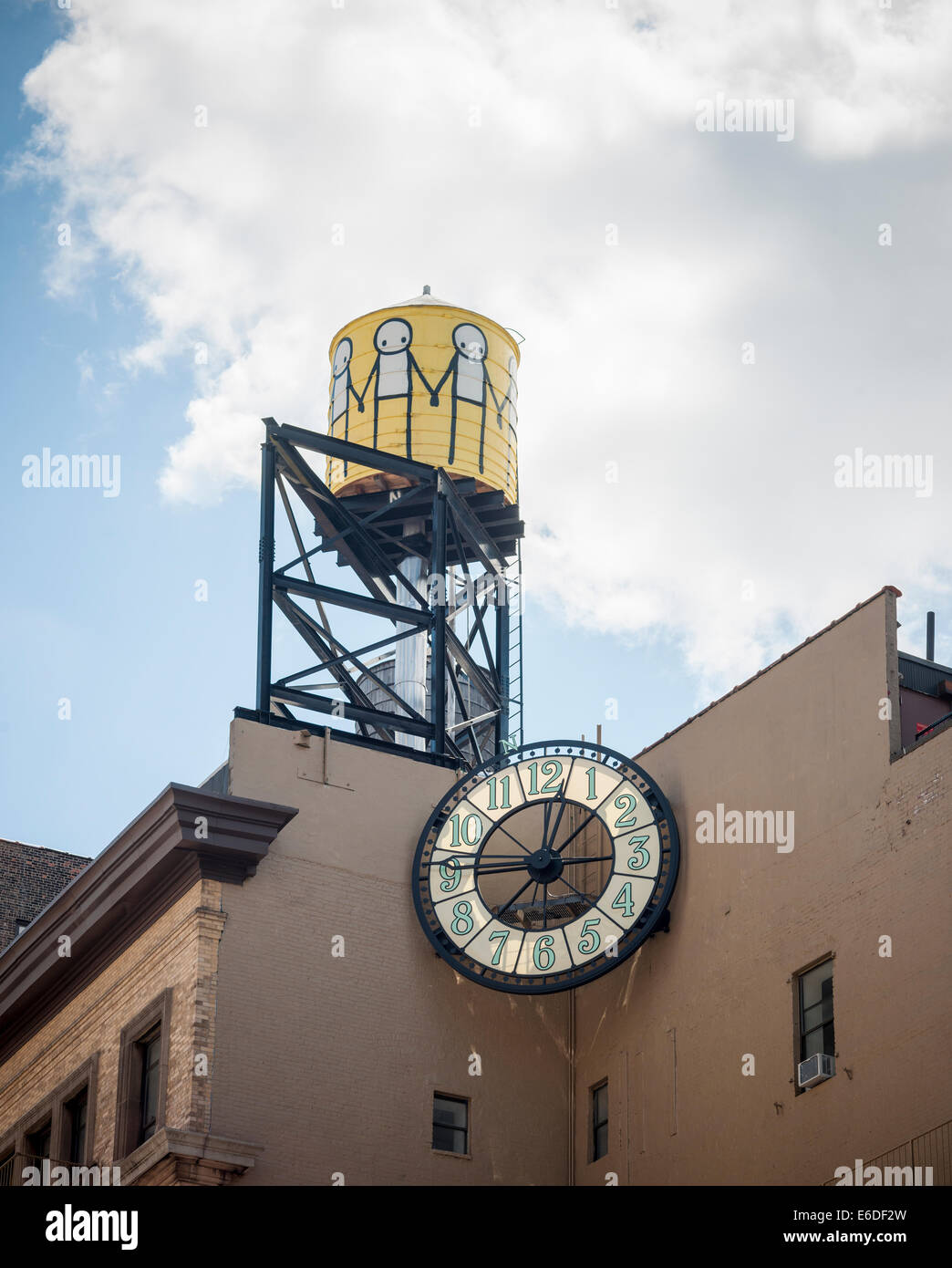 A new clock and a decorated water tank above 127 Fourth Avenue in the ...