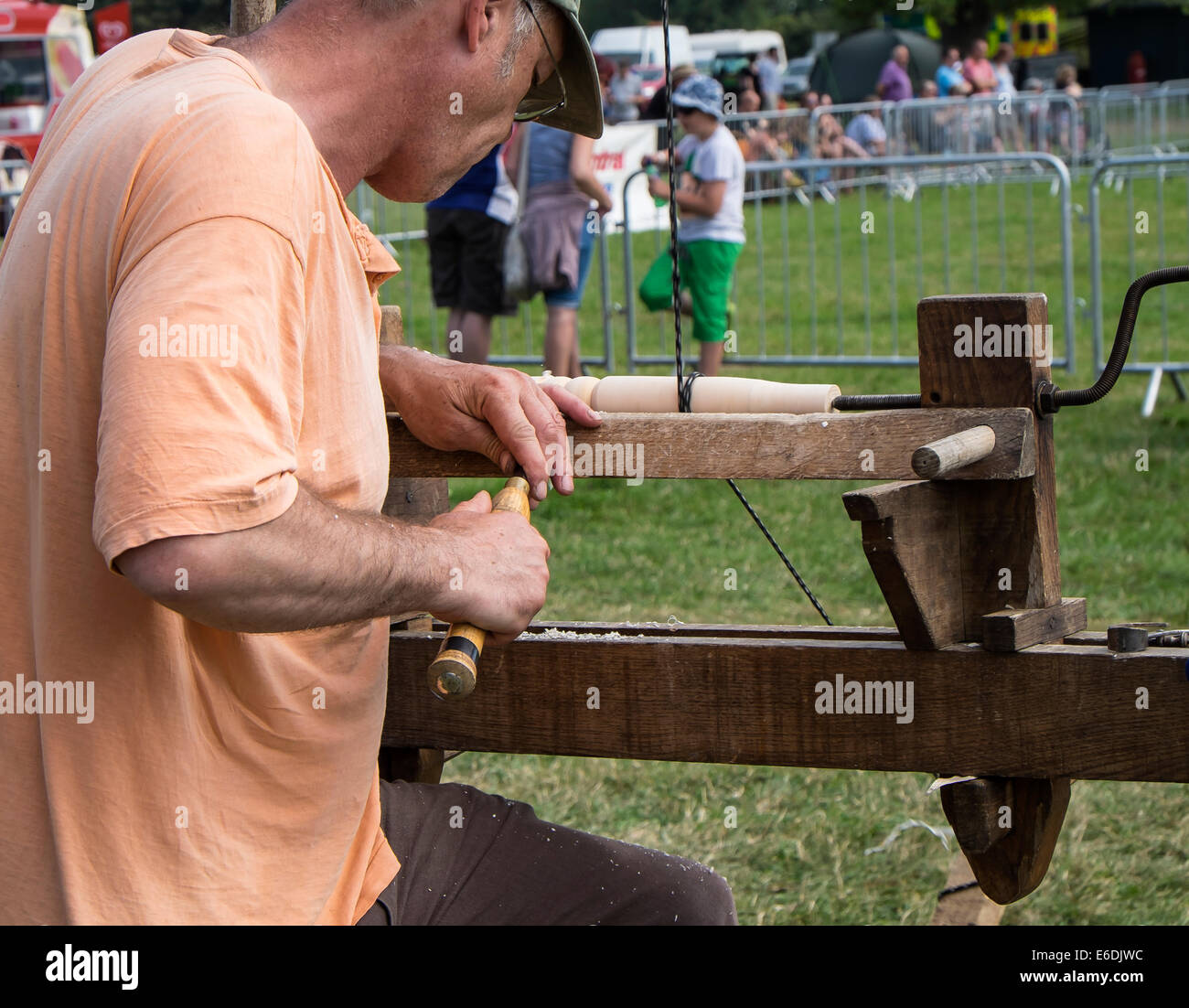 Wood turner using pole lathe to manufacture turned wood products at ...