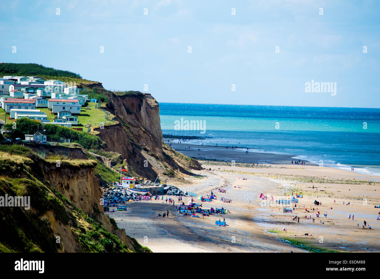 Cromer beach packed out on rarely sunny British day. Holiday homes ...