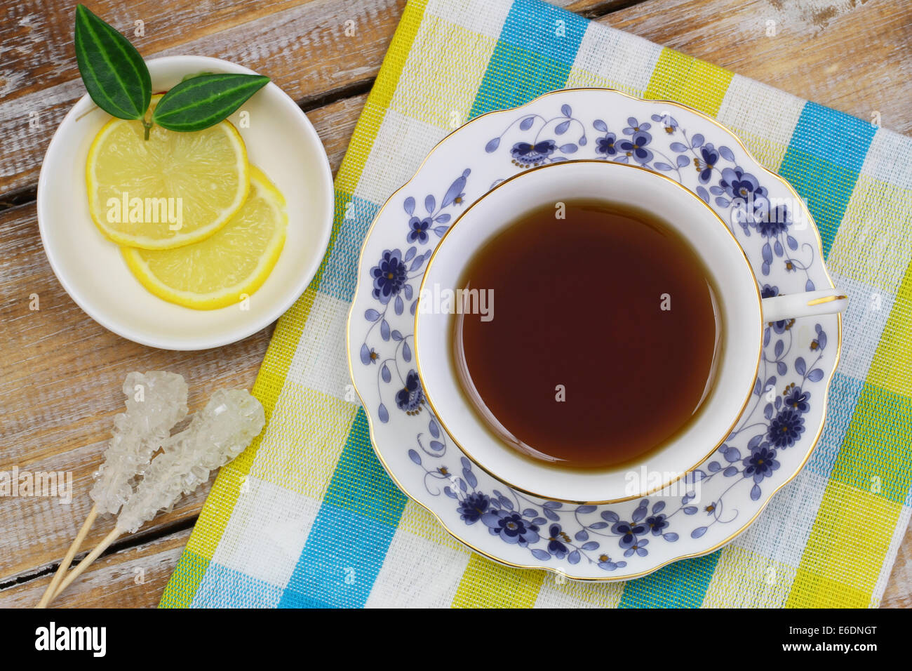 Tea in vintage cup and slices of lemon Stock Photo - Alamy