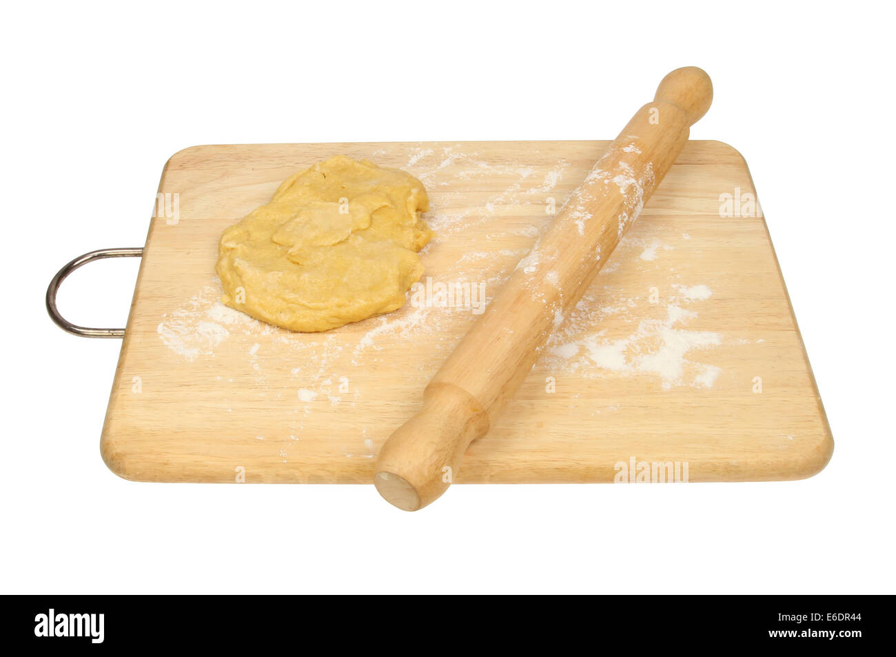 Pastry and a rolling pin on a floured board isolated against white ...
