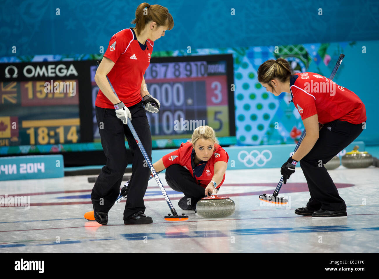 Anna Sloan (C) of Team Great Britain plays a stone with Claire Hamilton ...