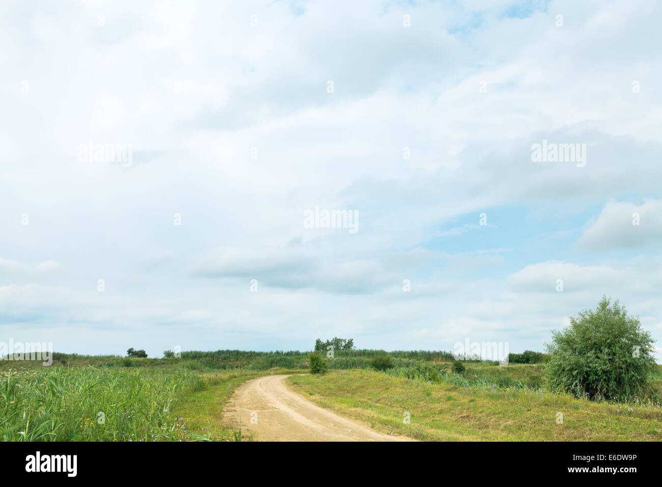 blue rainy clouds over country road in field Stock Photo - Alamy