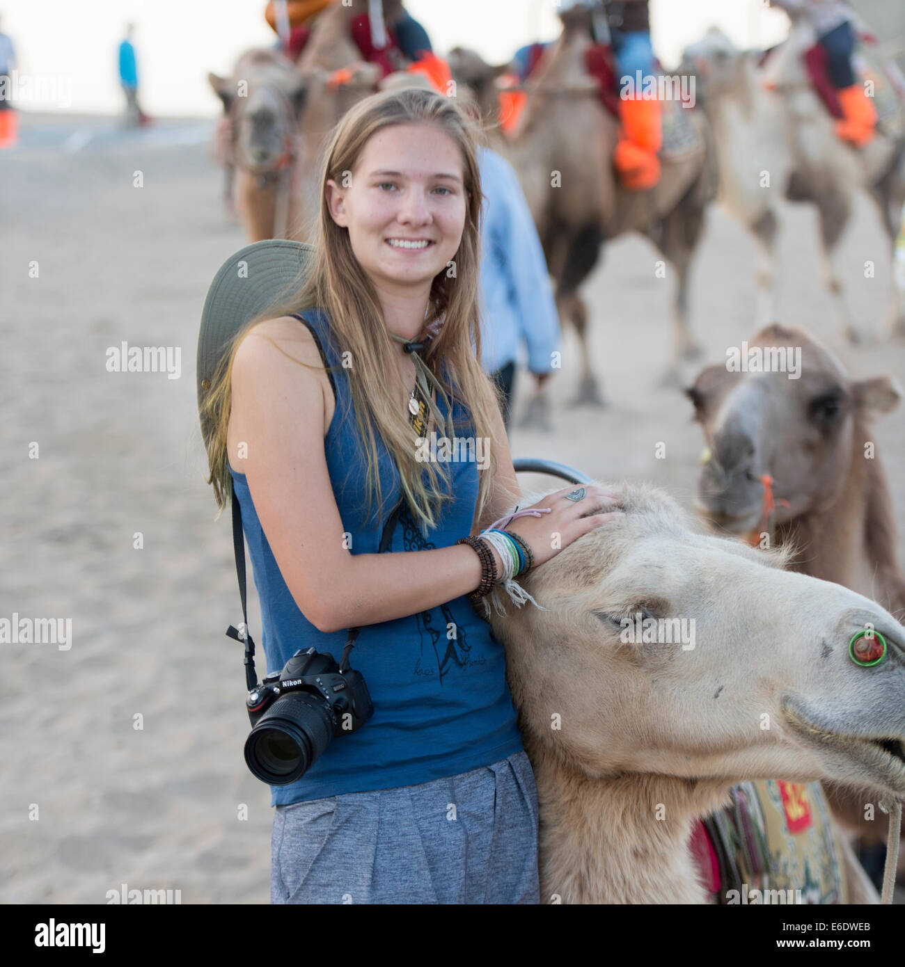 Woman with camel at Mingsha Shan, Dunhuang, Jiuquan, Gansu Province ...