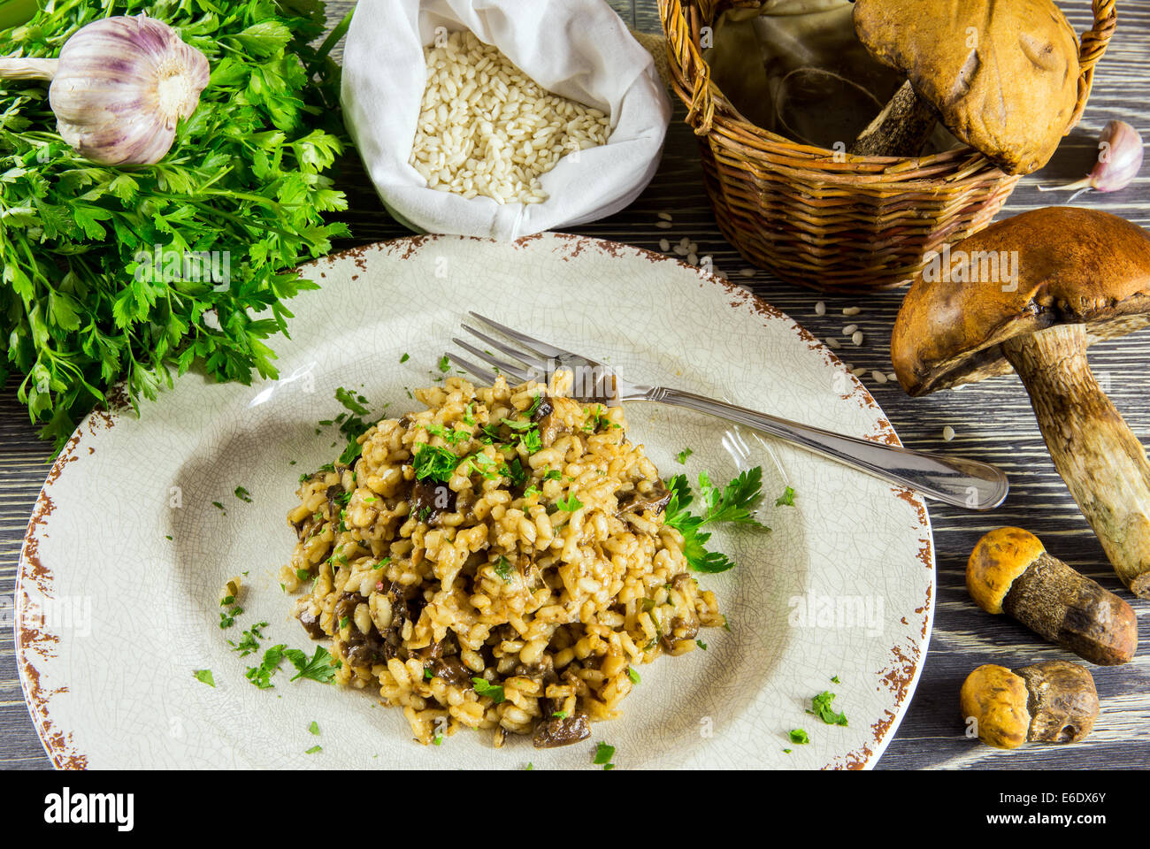 Italian risotto with mushrooms arranged on a wooden table Stock Photo ...