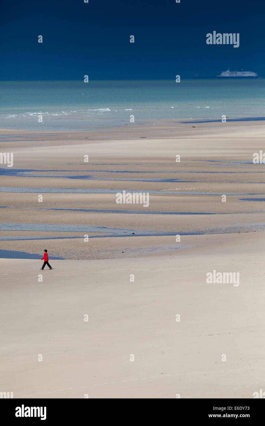 A boy in red walks on a beach near Cap Blanc Nez in the Pas de Calais ...