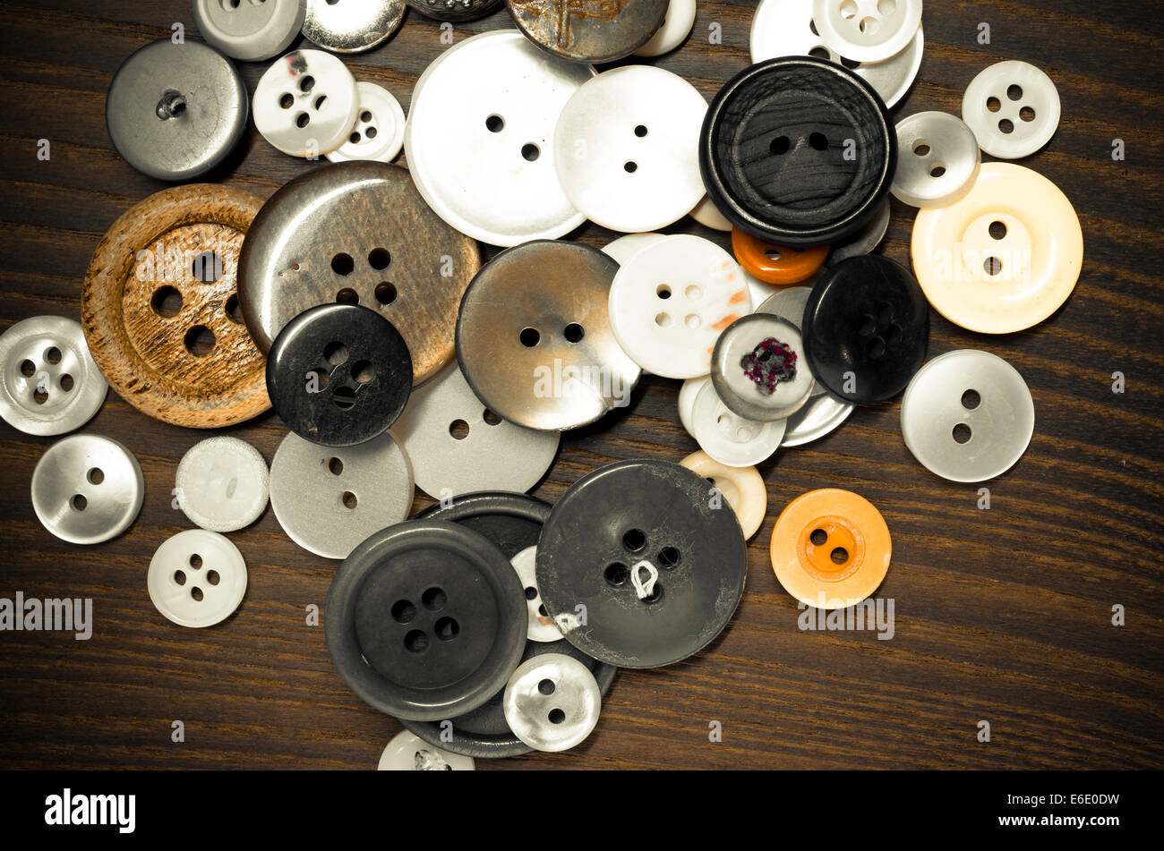 old clothing buttons, dark wood background Stock Photo - Alamy