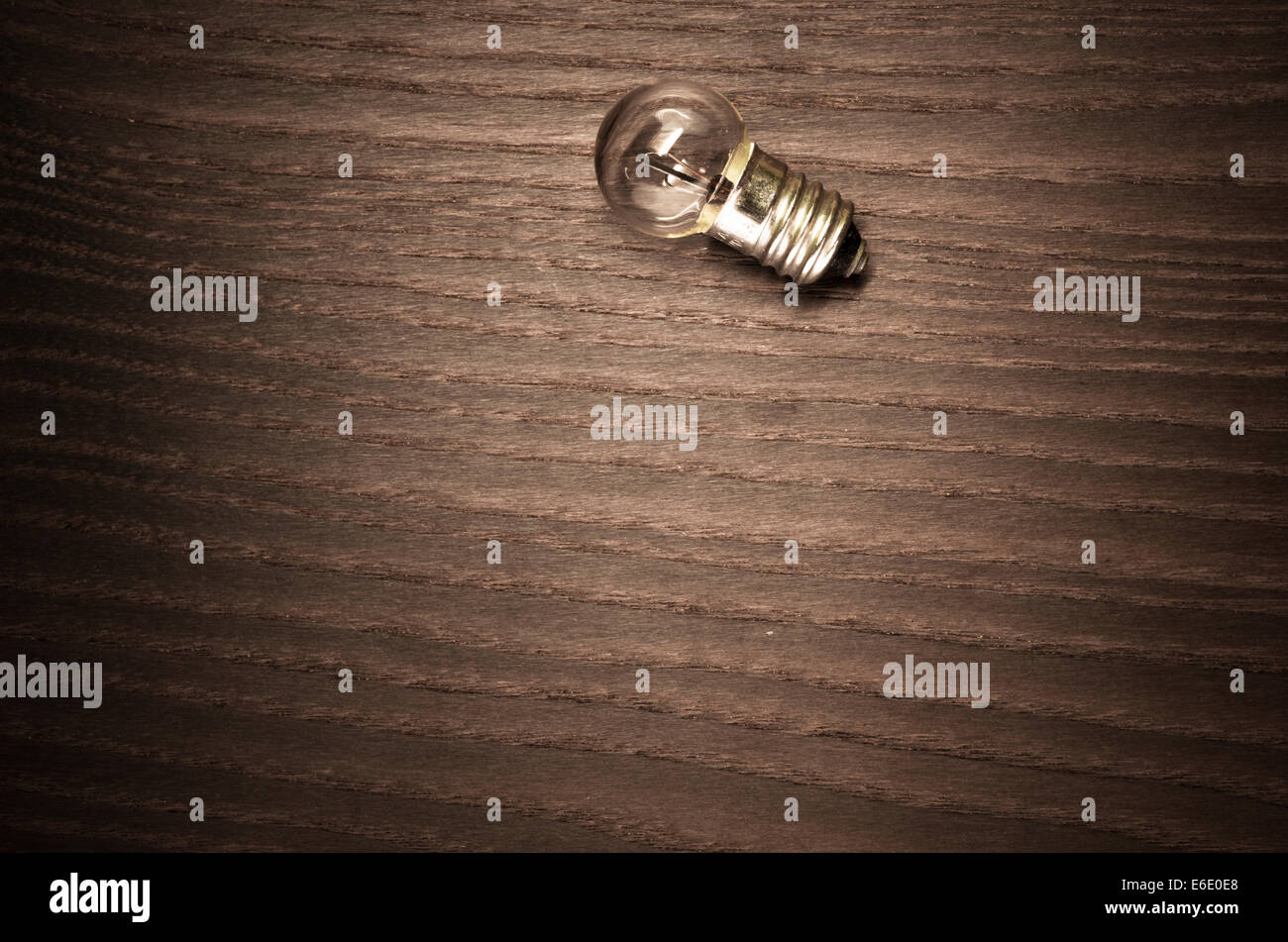 light bulb on a wood surface Stock Photo - Alamy