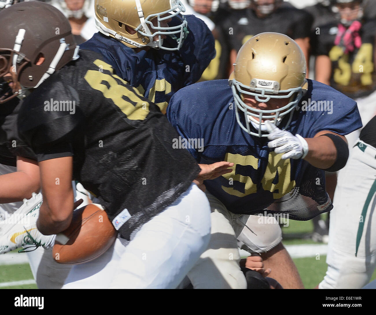 USA. 21st Aug, 2014. Atrisco Heritage's James Romero, right, gets a ...