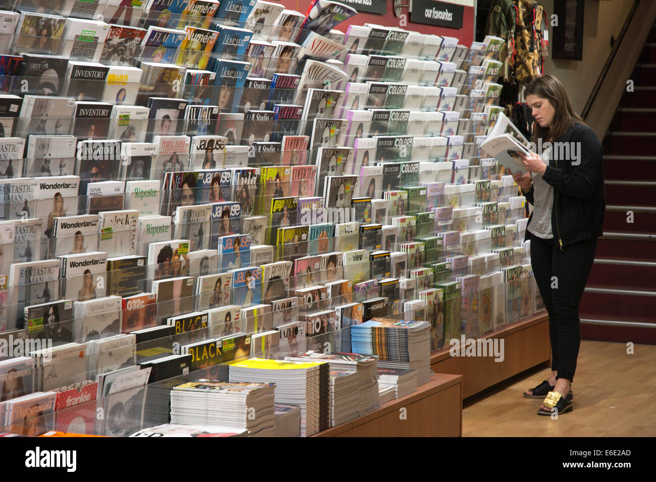 Woman browsing magazine Stock Photo - Alamy