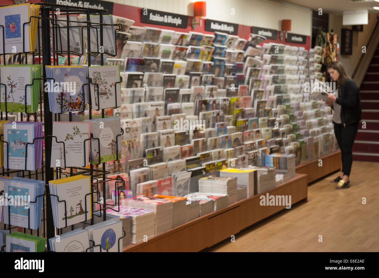 Woman browsing magazine Stock Photo - Alamy