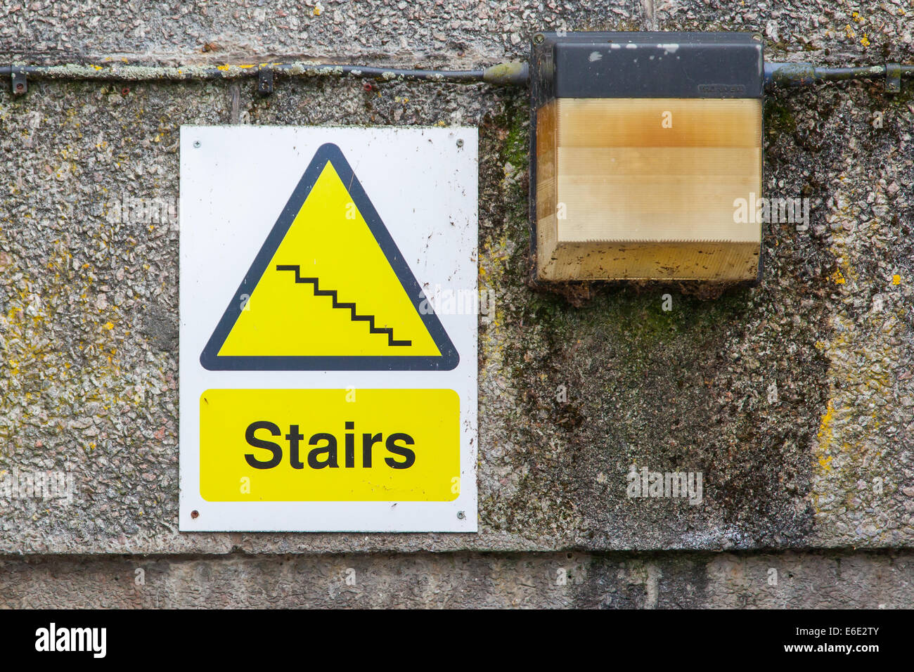 Plastic sign on a concrete wall, stairs Stock Photo - Alamy