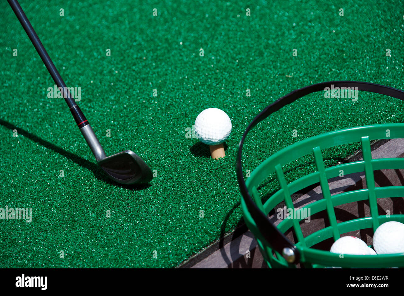 A golf ball and a driver in a practice club Stock Photo - Alamy