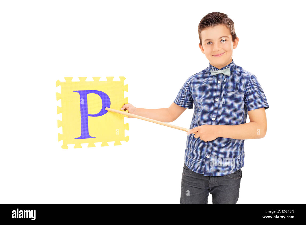 Boy pointing on a piece of puzzle with a stick isolated on white ...