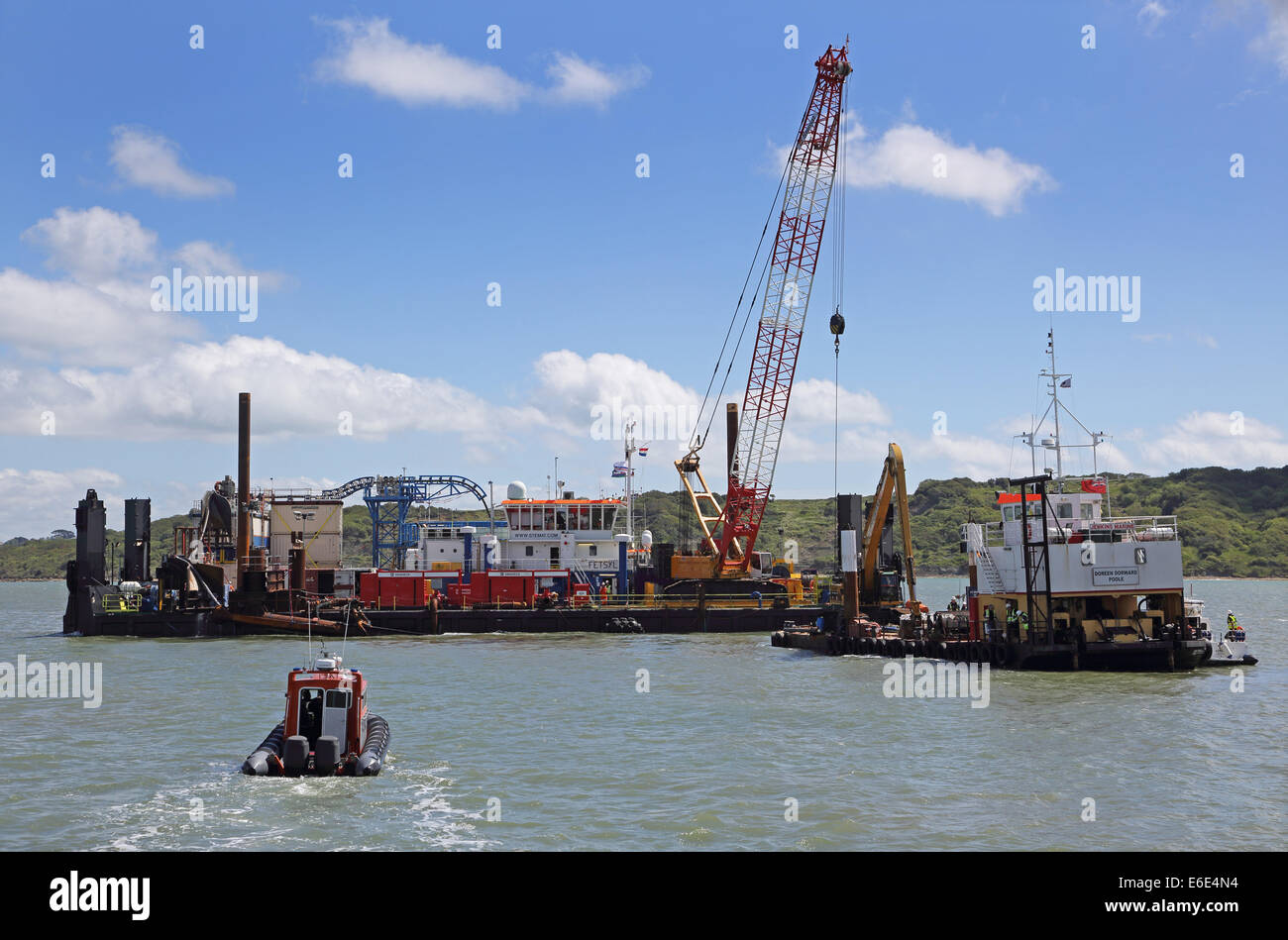Offshore marine cable laying operation in the Solent, UK. A barge lays ...