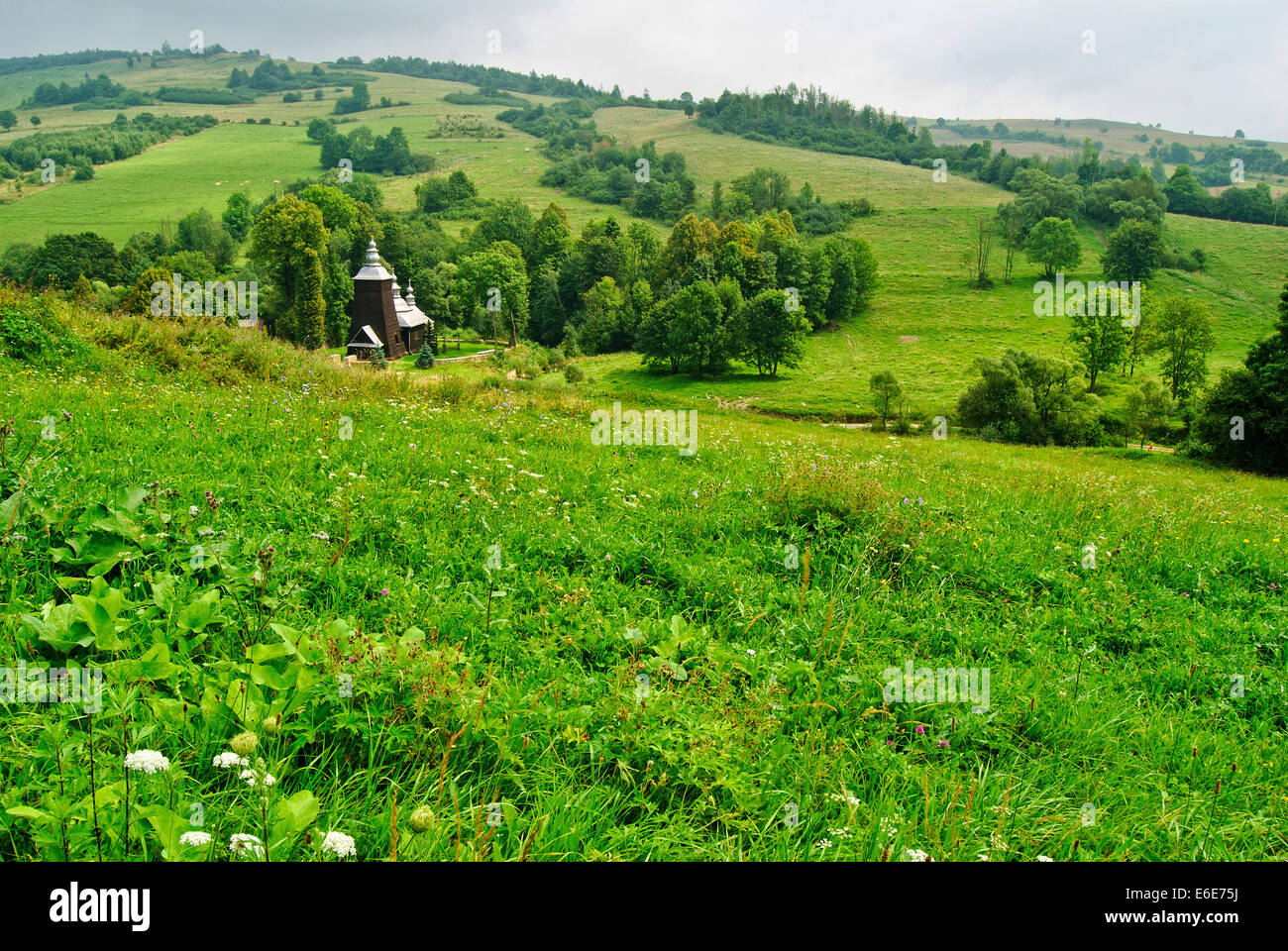 Rural landscape in Poland with wooden church in Chyrowa Stock Photo - Alamy