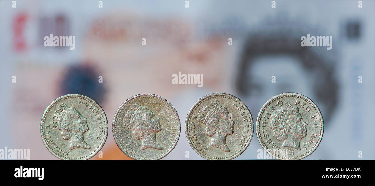 £1 British Stirling coins are pictured in front of a £10 British ...