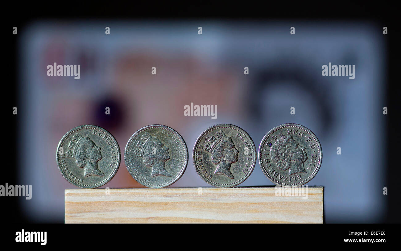 £1 British Stirling coins are pictured in front of a £10 British ...