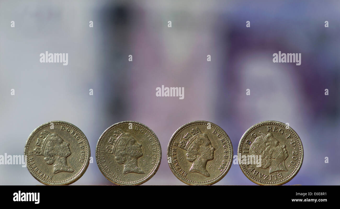 £1 British Stirling coins are pictured in front of a £20 British ...