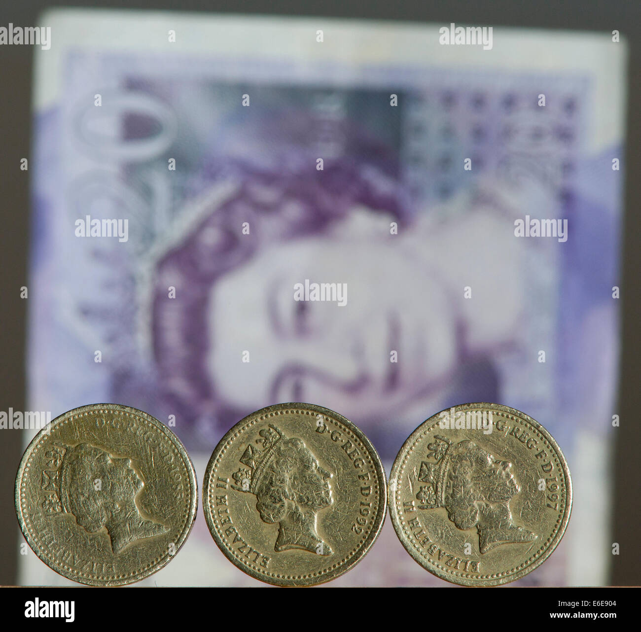 £1 British Stirling coins are pictured in front of a £20 British ...