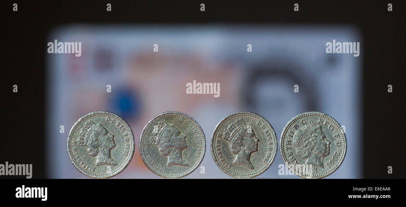 £1 British Stirling coins are pictured in front of a £10 British ...