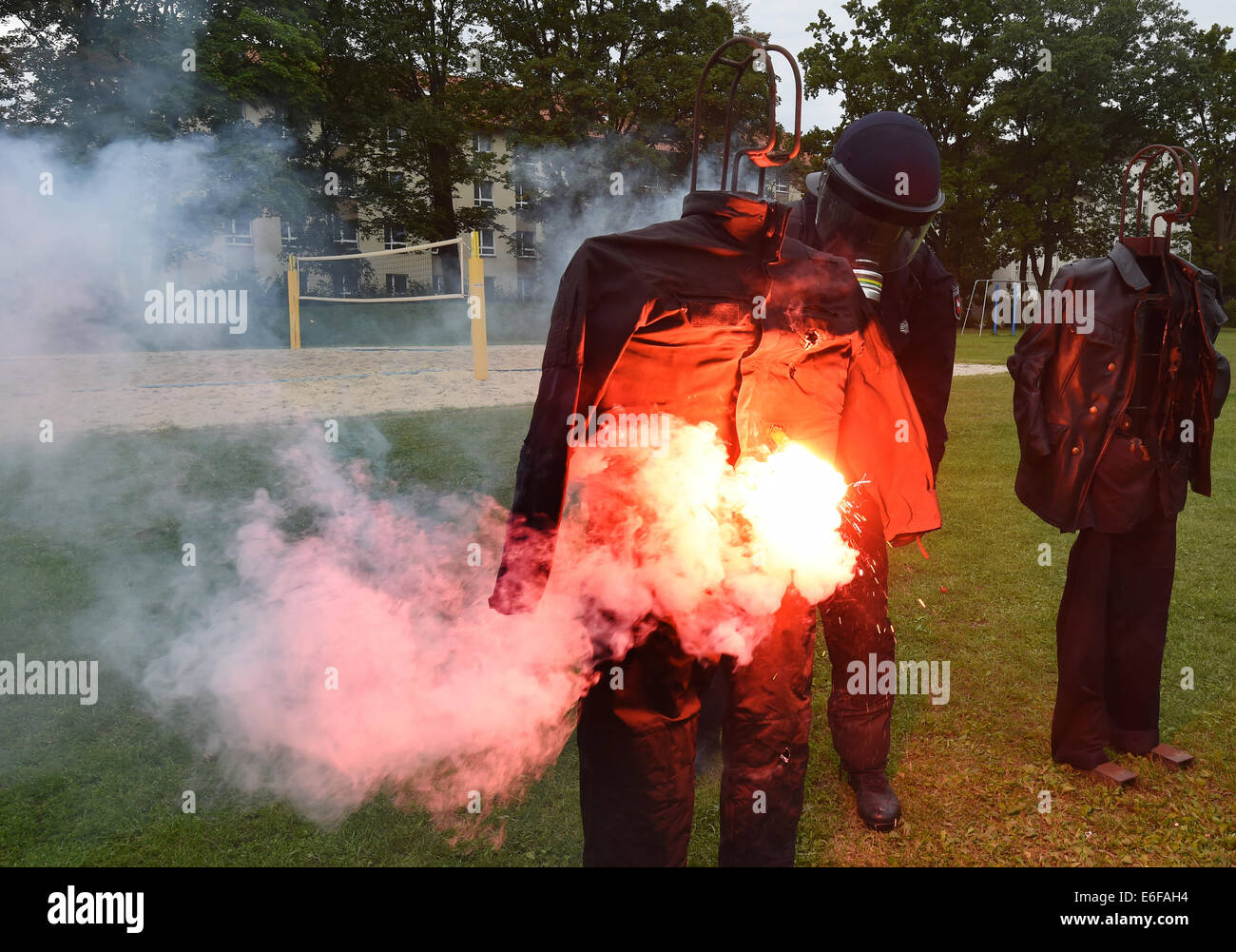 Hanover, Germany. 22nd Aug, 2014. A riot policeman wears a fire ...
